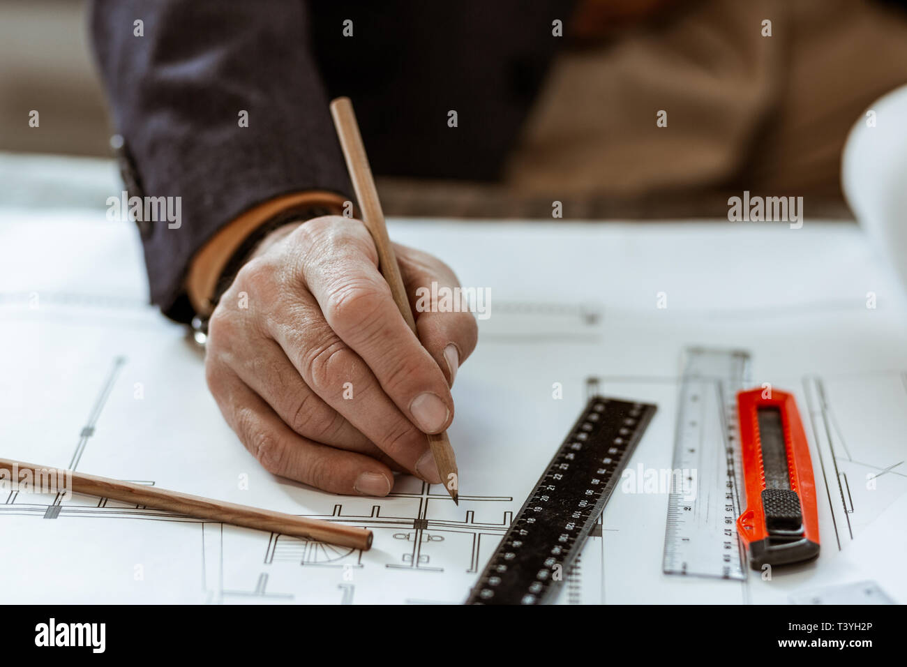 Painting drafts. Close up of interior designer wearing dark jacket ...