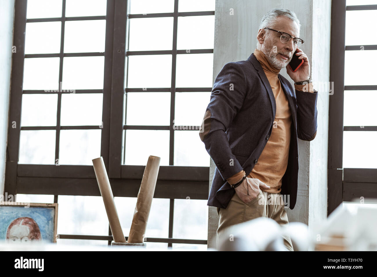 Calling client. Interior designer calling his client and arranging ...