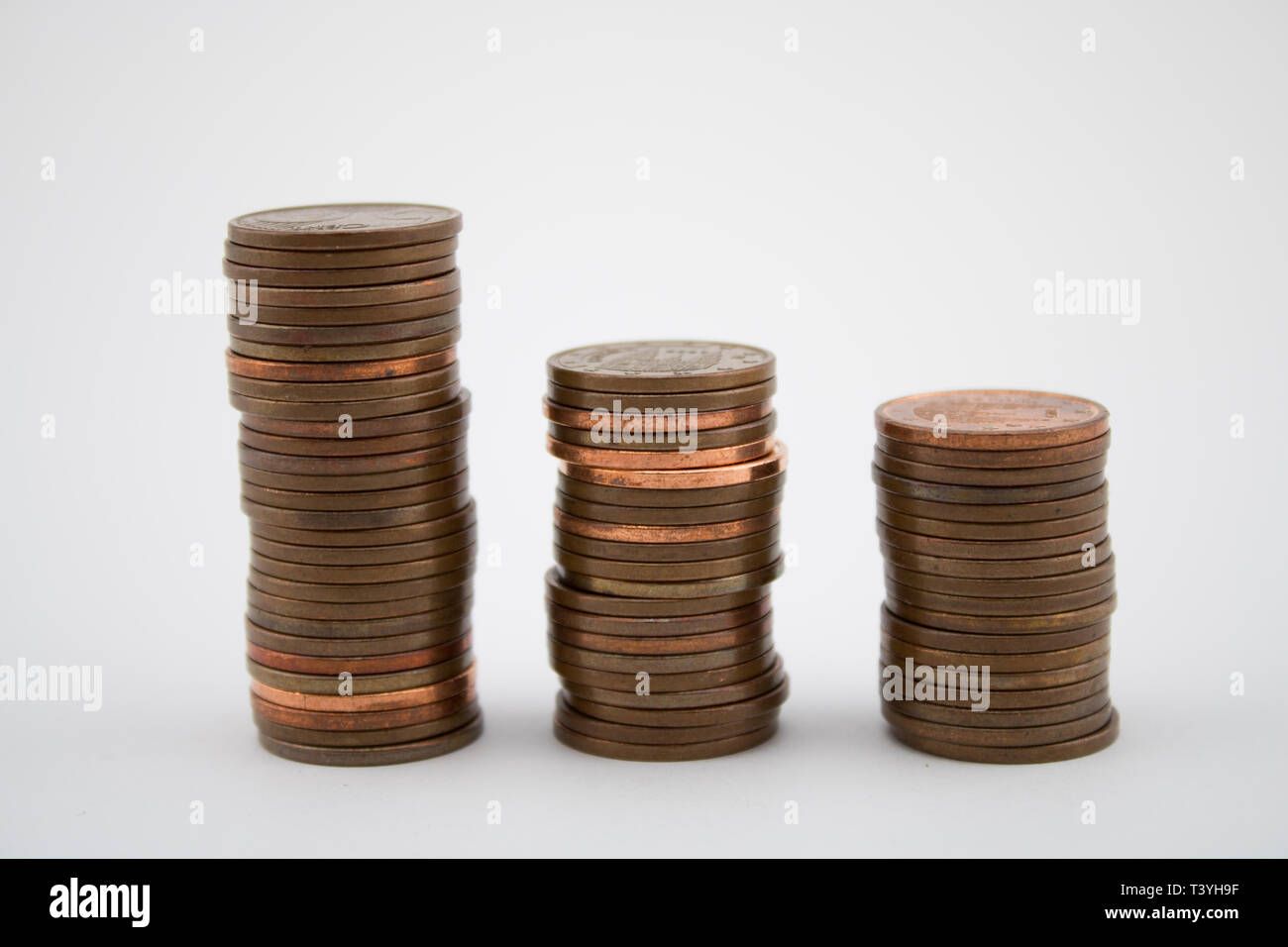 Stack of bronze coins on white background. Coins of five euro cents ...