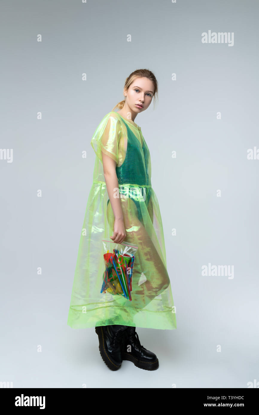 Plastic clothes. Professional blonde-haired model posing in plastic ...