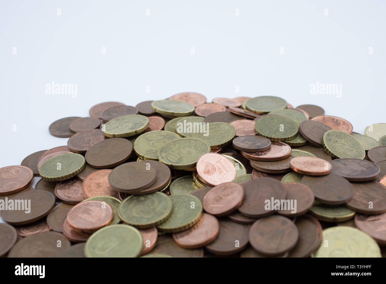Many euro cents coins on white background. Savings of coins. Coins of ...