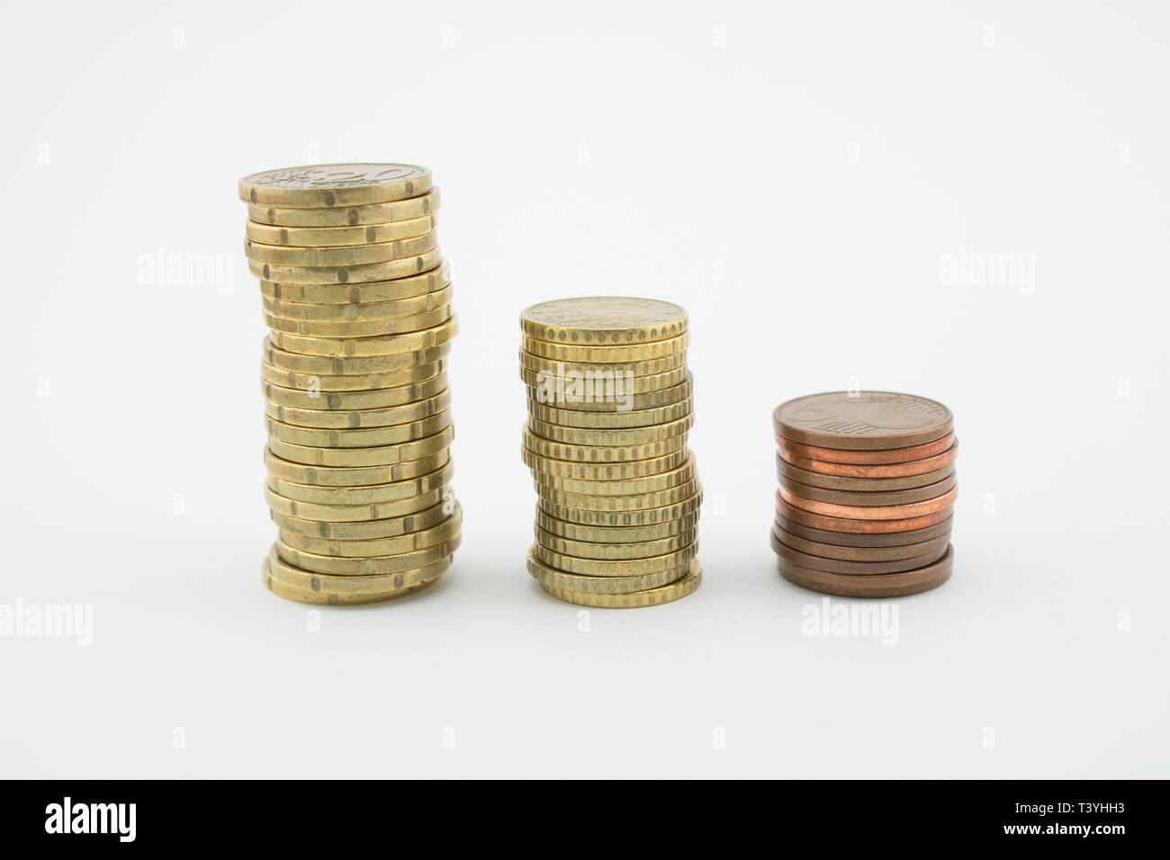 Stack of golden and bronze coins on white background. Coins of twenty ...