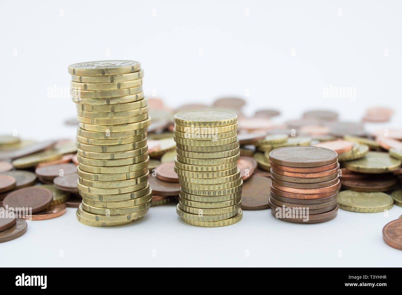 Stack of golden and bronze coins on white background. Coins of twenty ...