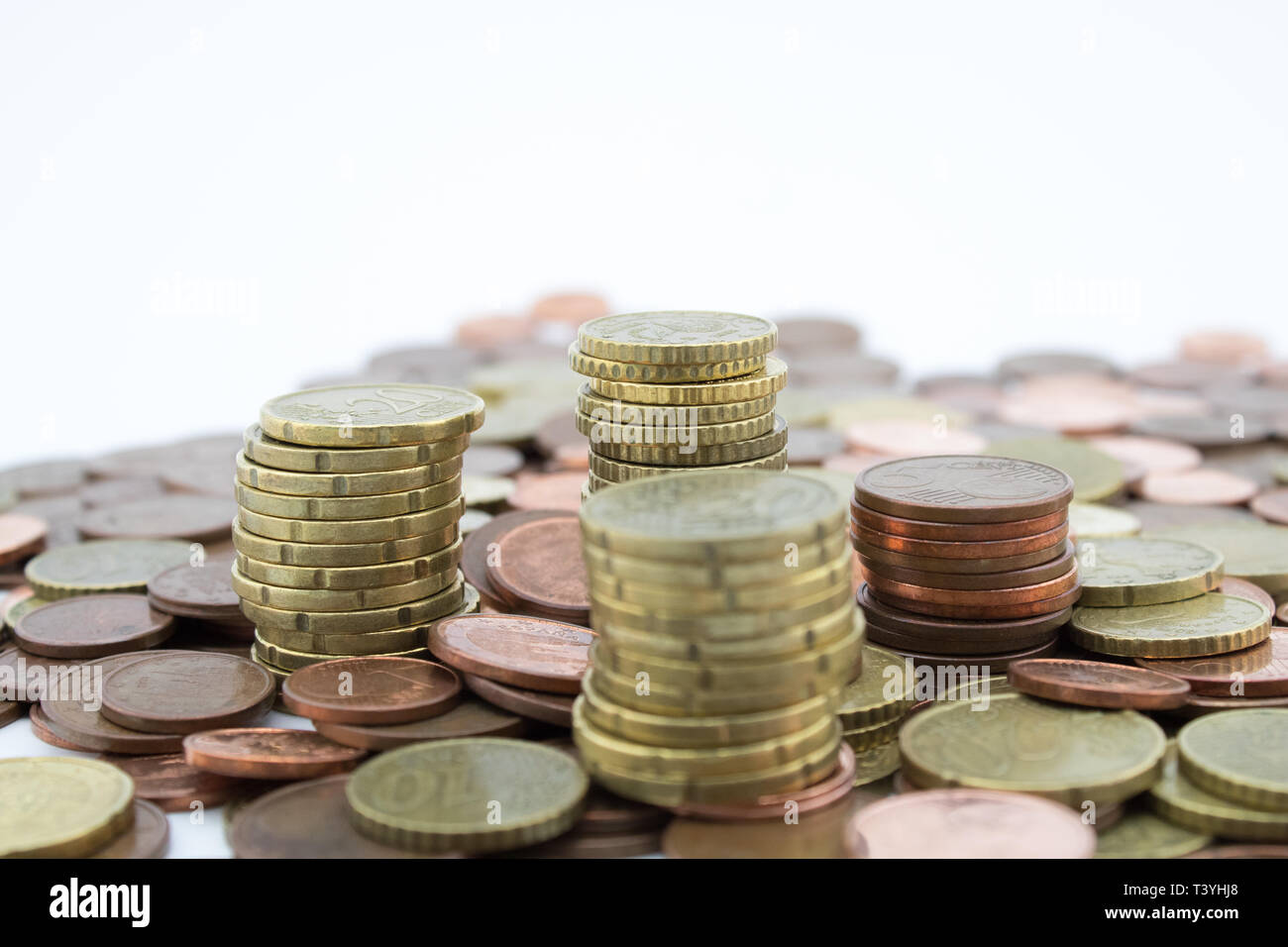 Stack of euro cents coins of different value on white background ...