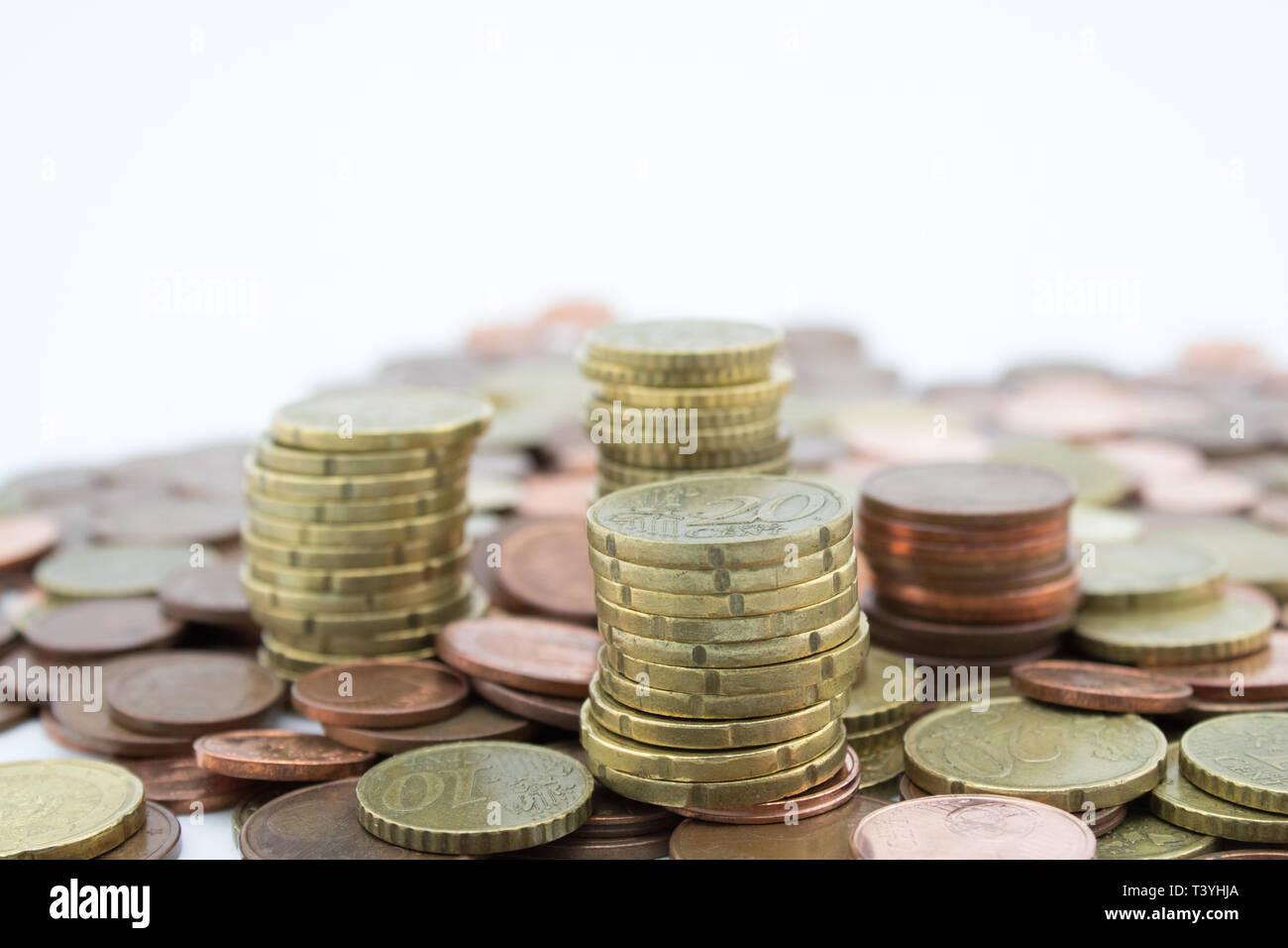 Stack of euro cents coins of different value on white background ...