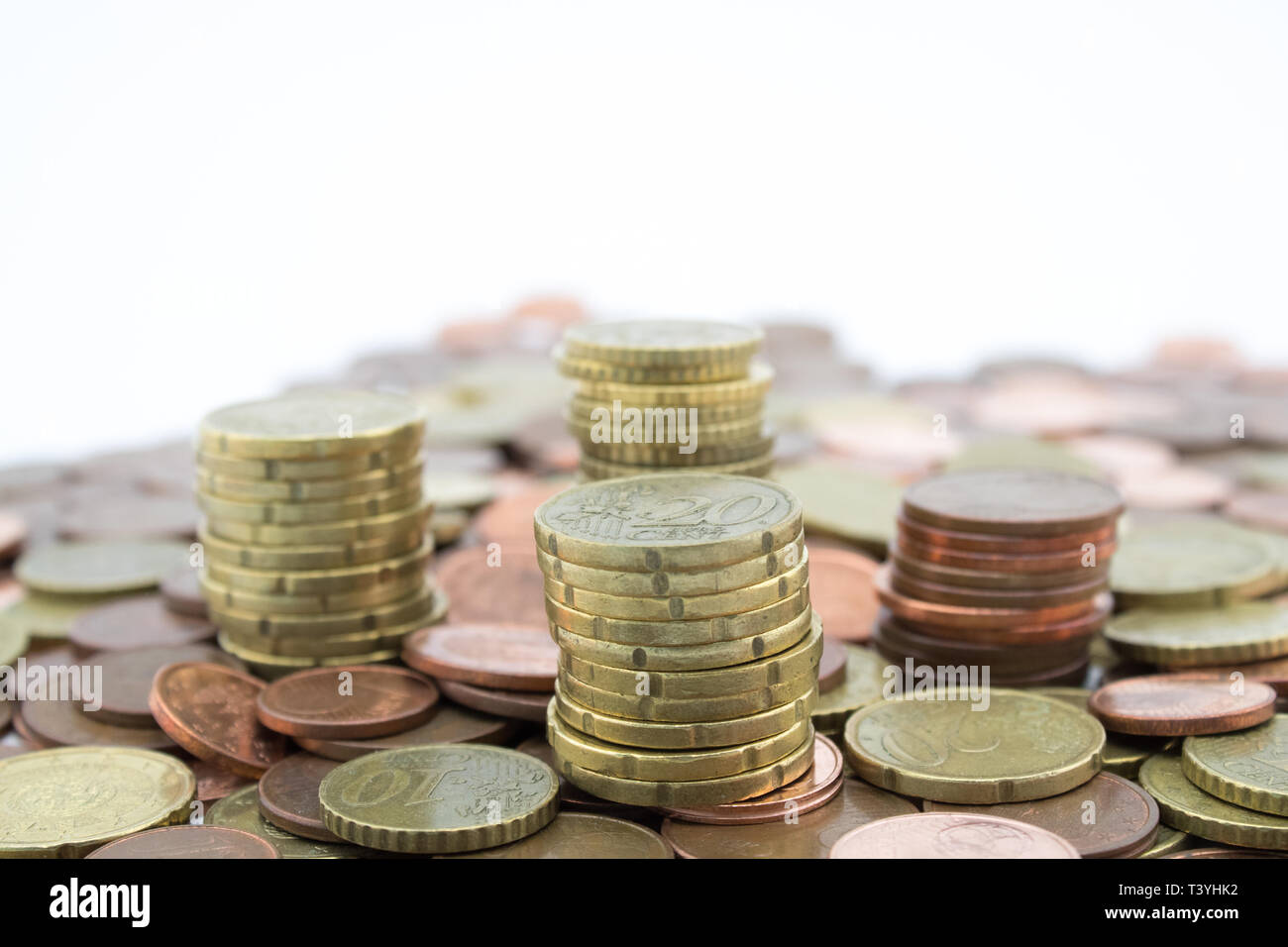 Stack of euro cents coins of different value on white background ...