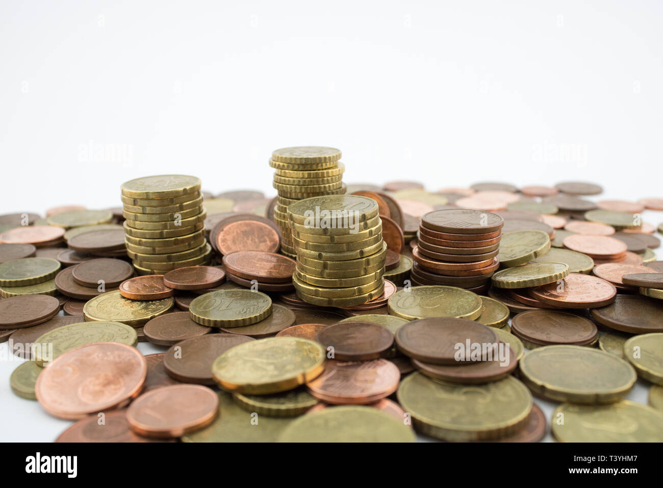 Stack of euro cents coins of different value on white background ...