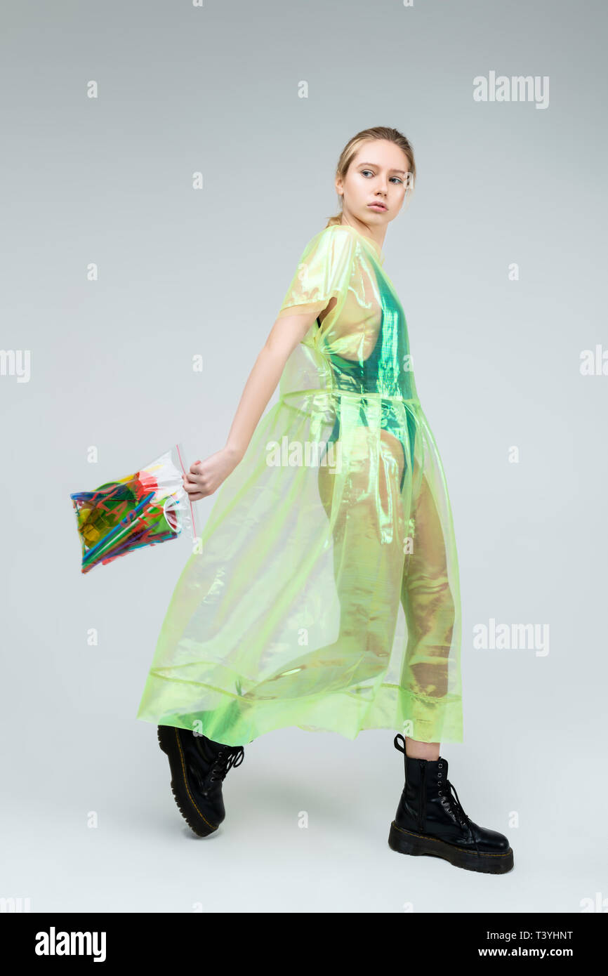 Plastic on body. Blonde-haired young promising model posing near grey ...