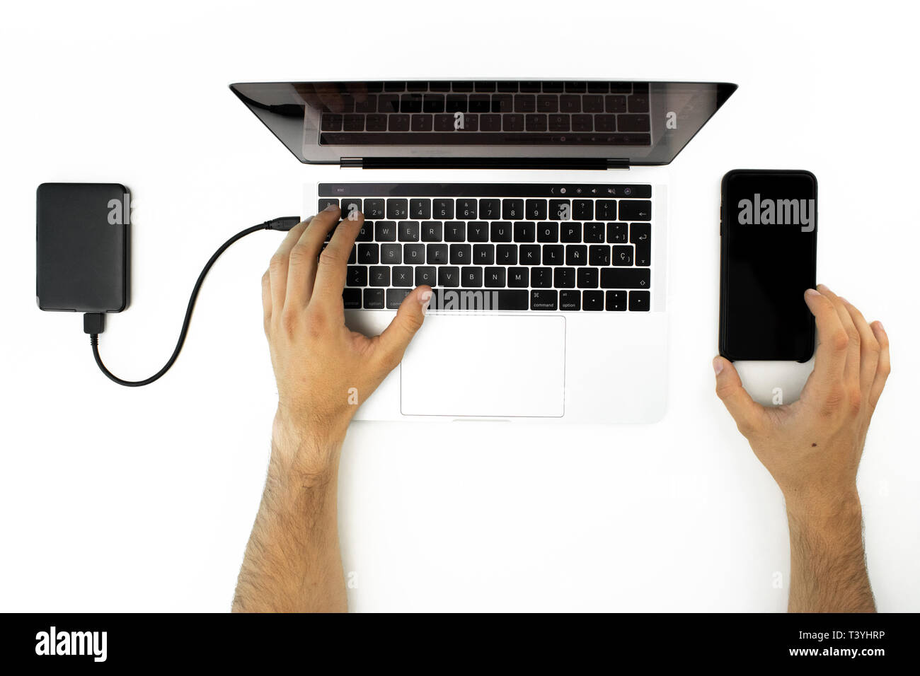 Businessman working with his laptop computer and his smartphone on a ...