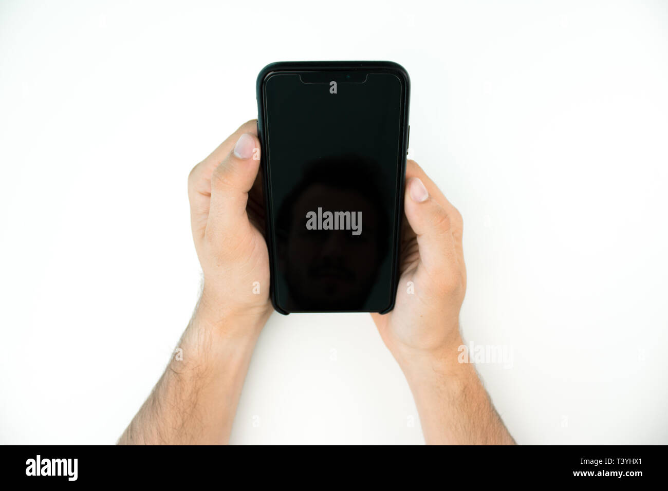 Business person using his smartphone on a white table. Modern workplace ...