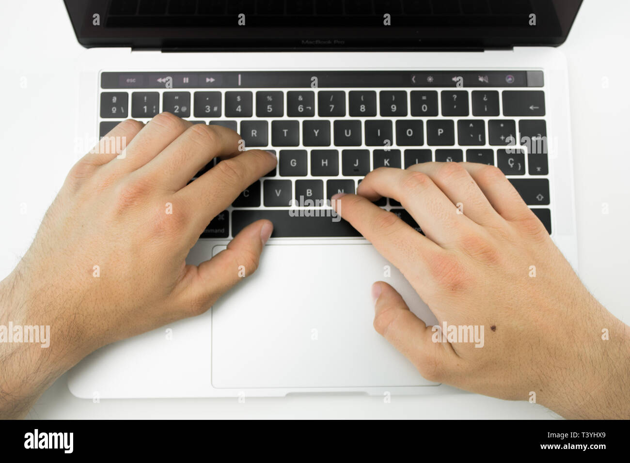 Business person using the keyboard and the touchpad of a laptop on a ...