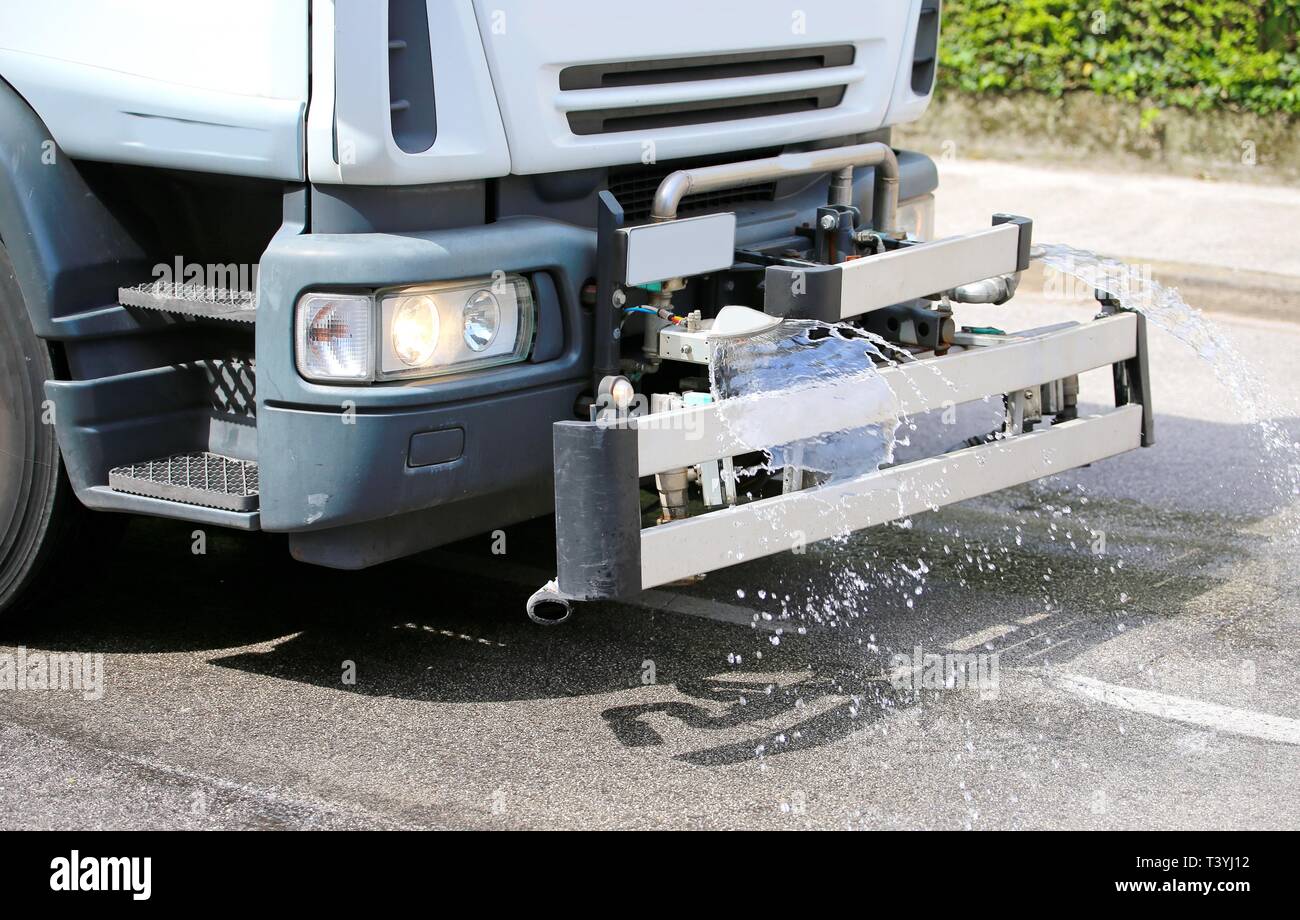 truck for cleaning the roads in the city with water Stock Photo - Alamy