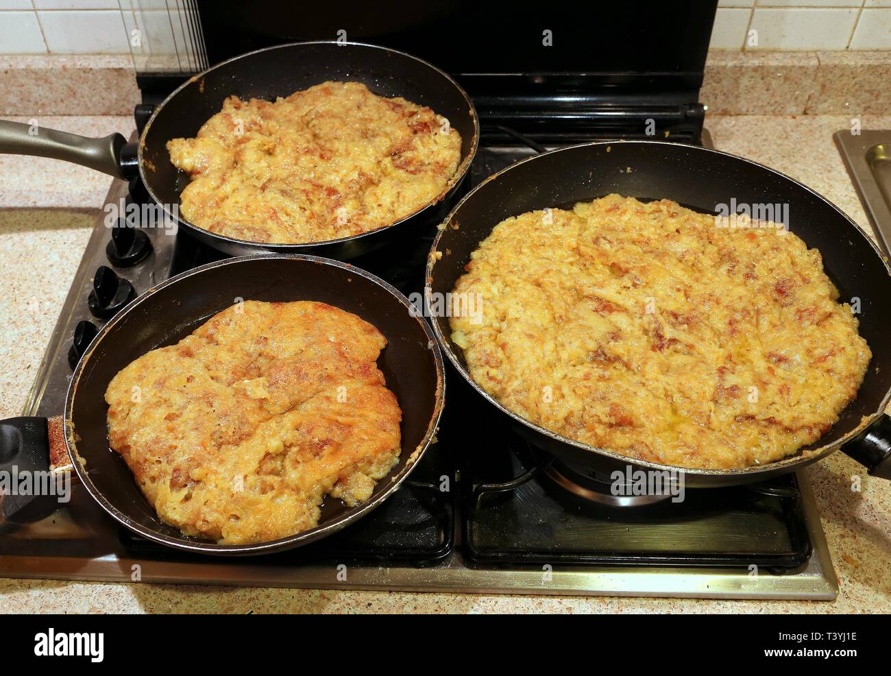 three pots of Frico a typical italian food of Friuli Region in Italy ...