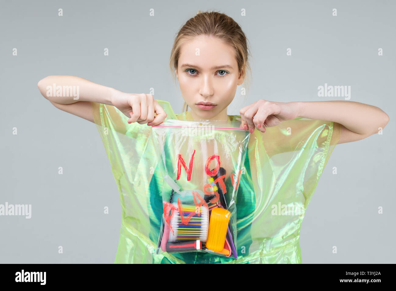 Full of plastic. Aggressive angry blonde-haired model posing with ...