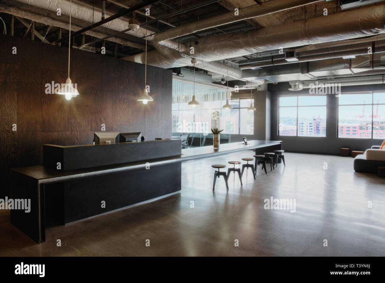Stools at bar by reception desk in office Stock Photo - Alamy
