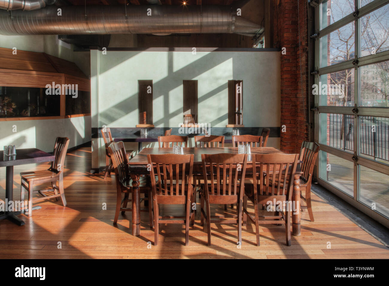 Tables and chairs in empty restaurant Stock Photo - Alamy