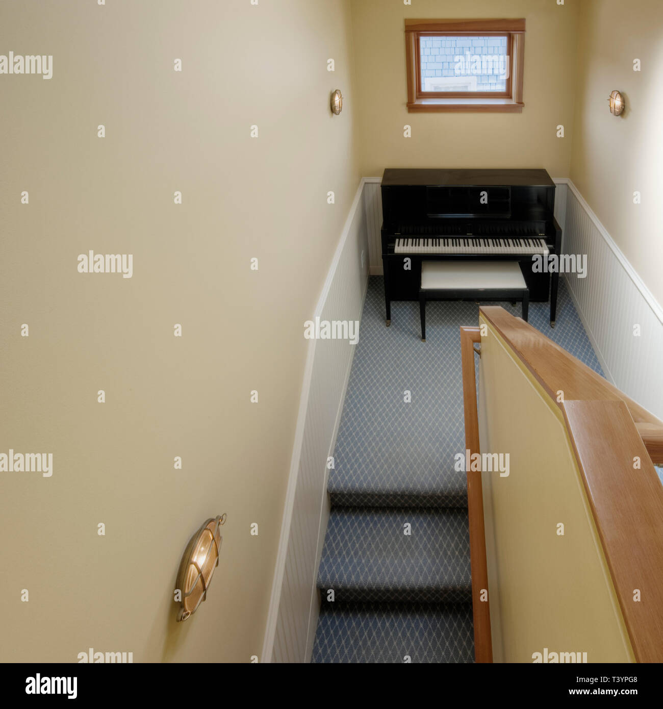 Piano on staircase in house Stock Photo - Alamy