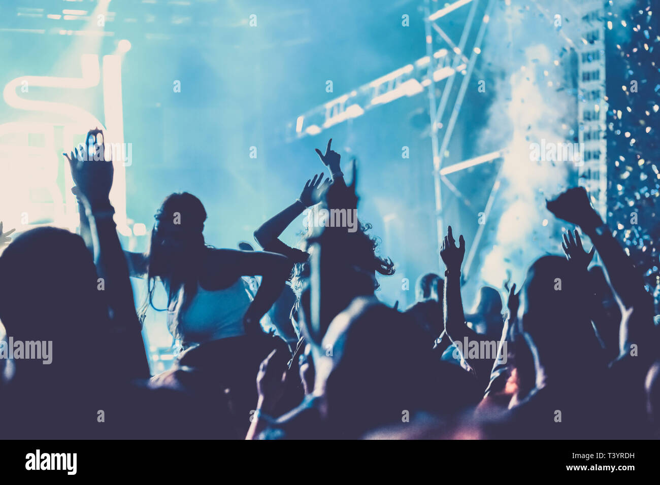 Crowd with raised up hands dancing in nightclub hi-res stock ...