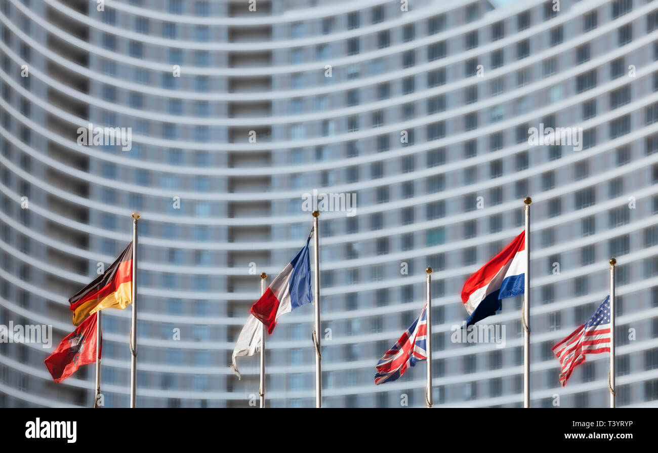 International flags in front of highrise Stock Photo - Alamy