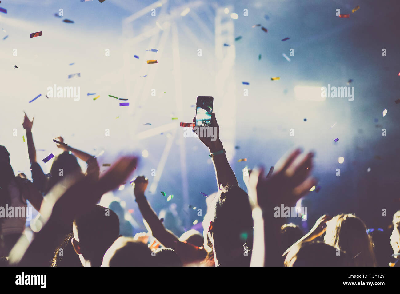 Group people arms up confetti hi-res stock photography and images - Alamy