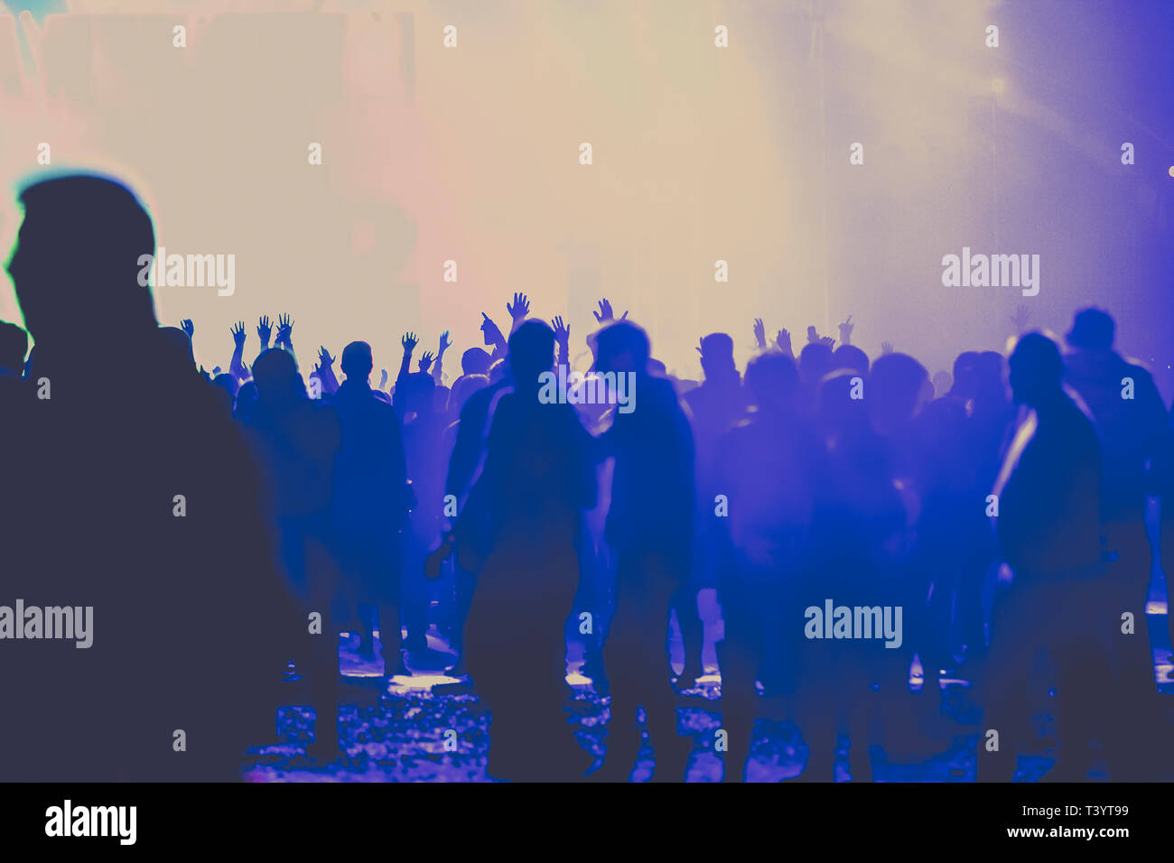 Crowd with raised up hands dancing in nightclub hi-res stock ...