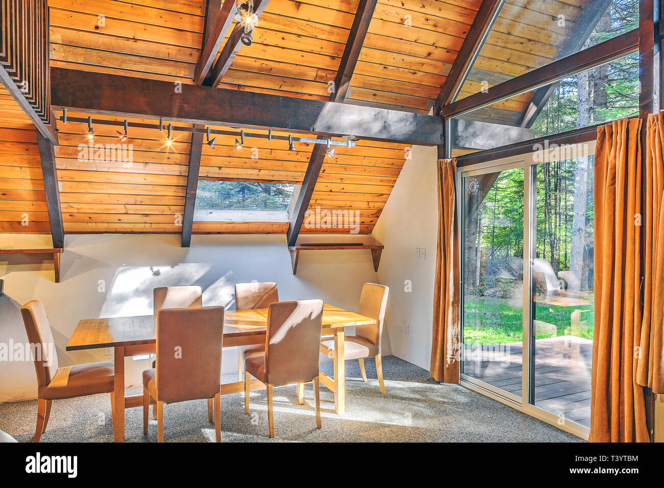 Dining table and windows in rustic dining room Stock Photo - Alamy