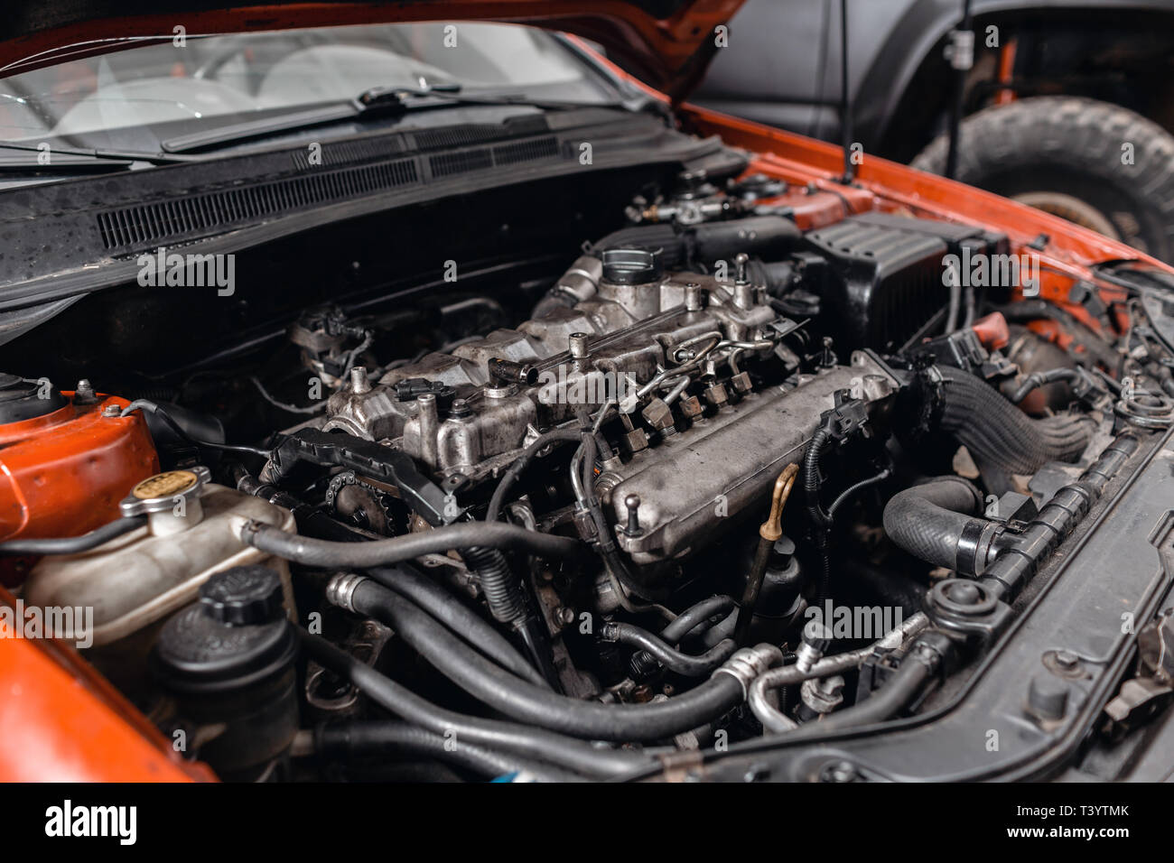 Close-up of the diesel engine of the car. The master repairs the car in ...