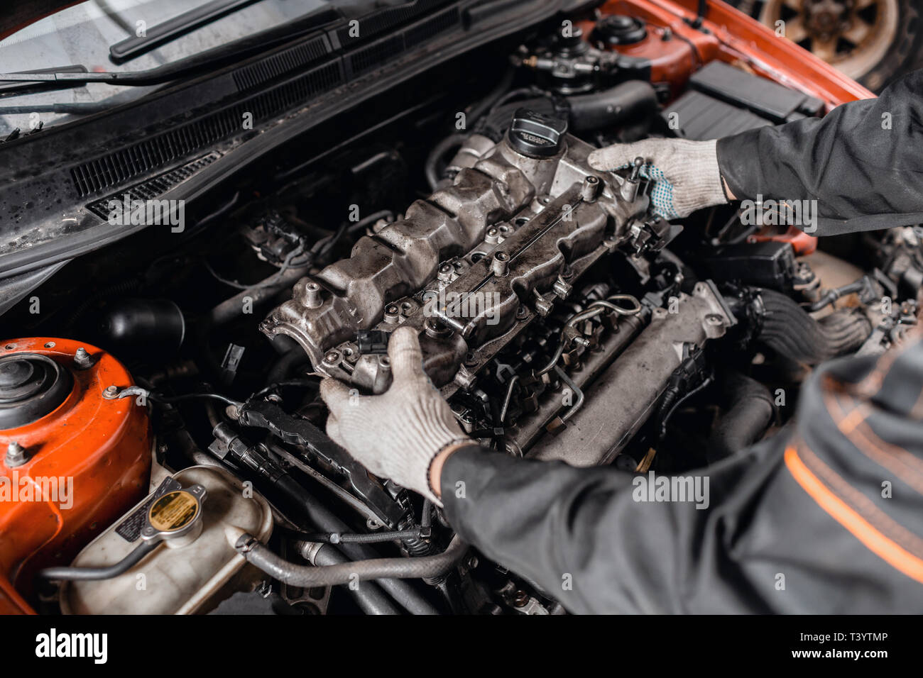 Mechanic take to pieces engine head. Repairing of modern diesel engine ...