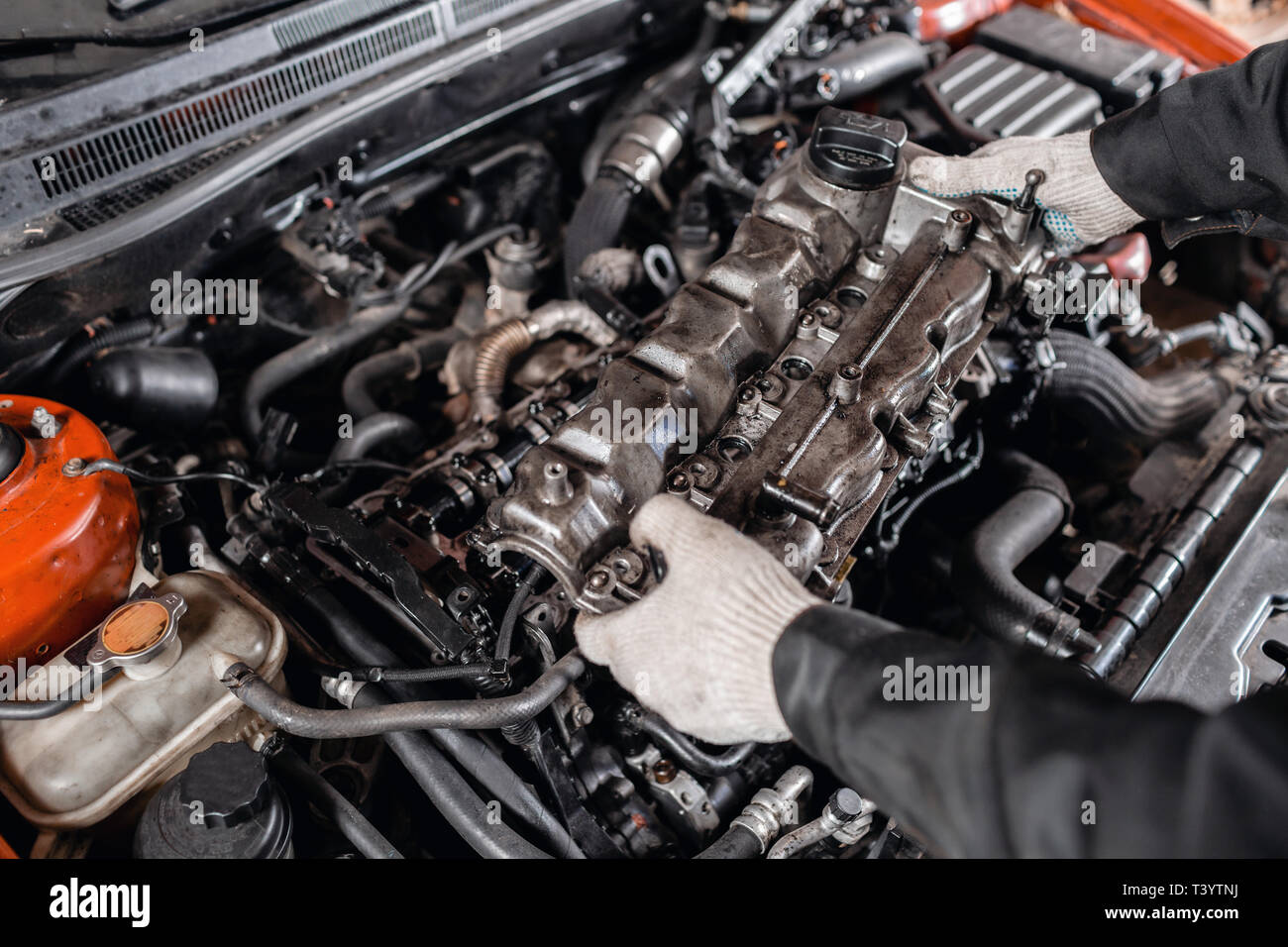 Mechanic take to pieces engine head. Repairing of modern diesel engine ...