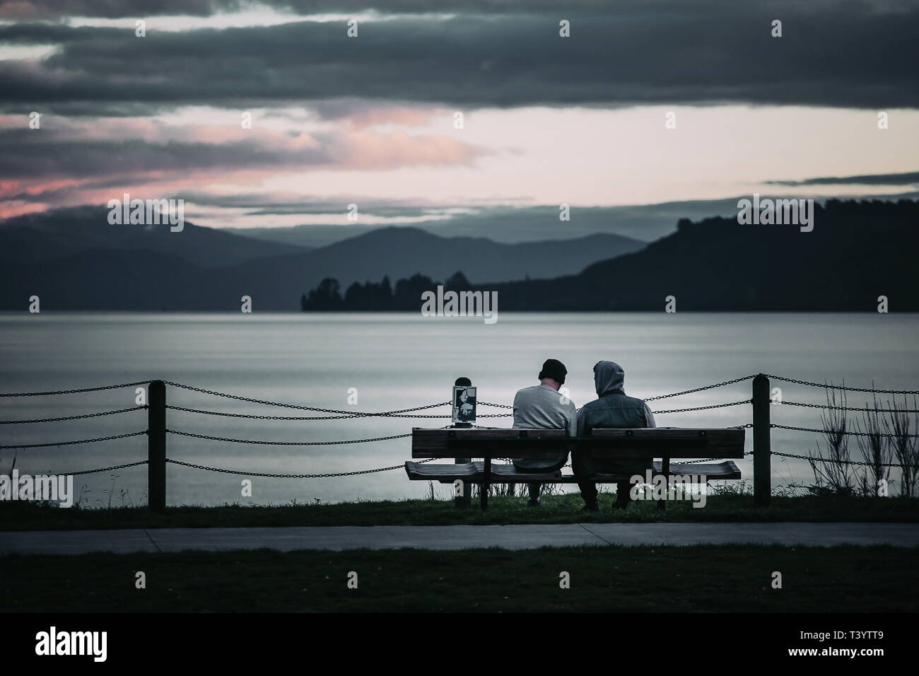 two people sitting on bench Stock Photo - Alamy