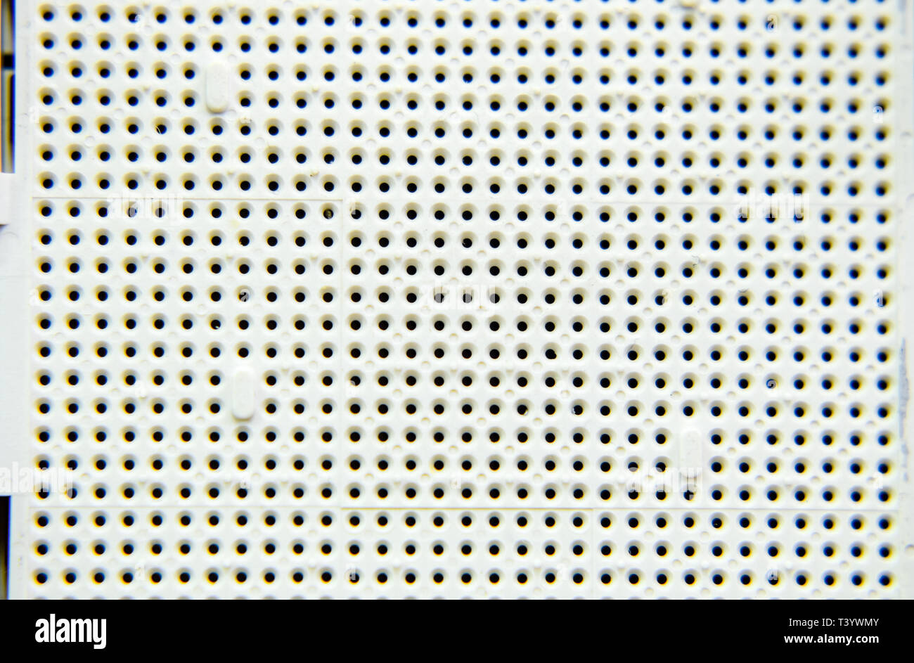 A socket under the processor of the computer, holes under the feet of ...