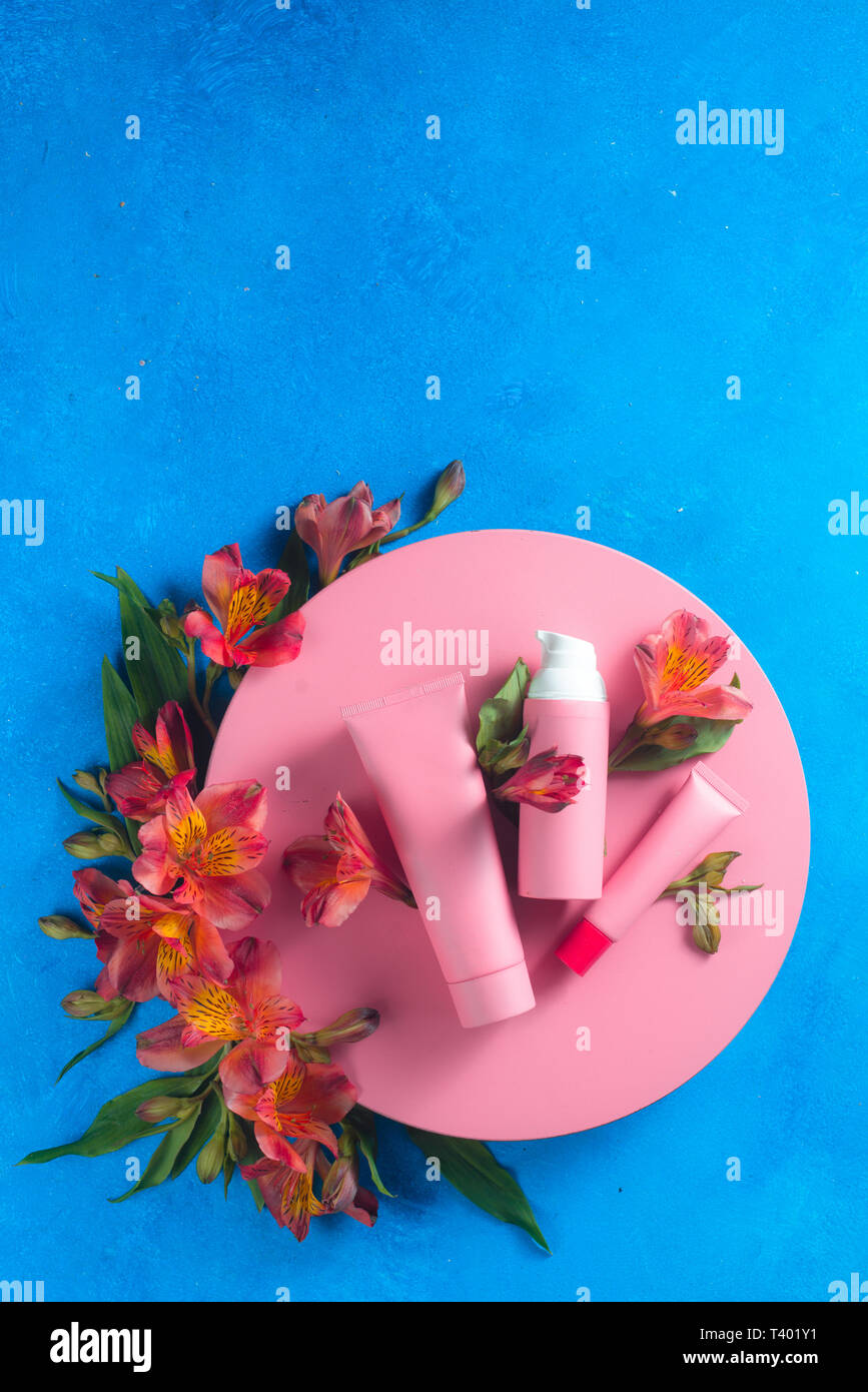 Sunscreen and skin care cosmetics in the pink palette in on a blue ...