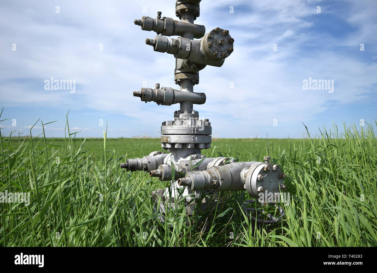Canned oil well against the sky and field. Equipment of an oil well ...