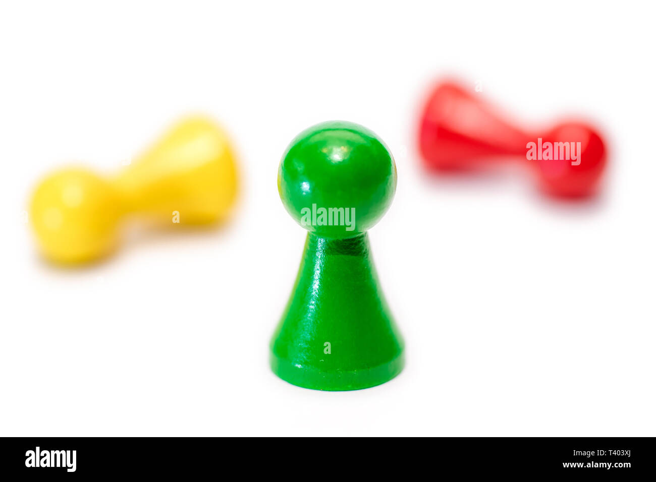 Green pawn wins against yellow and red on white background Stock Photo ...