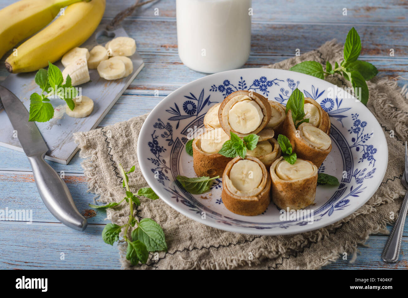 Delish sweet dessert with mint and sugar, fresh bio banana and milk ...