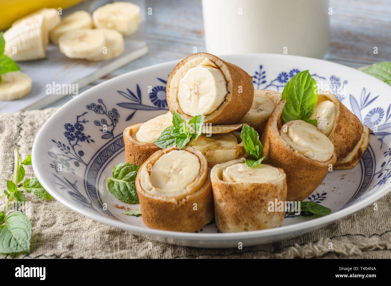 Delish sweet dessert with mint and sugar, fresh bio banana and milk ...