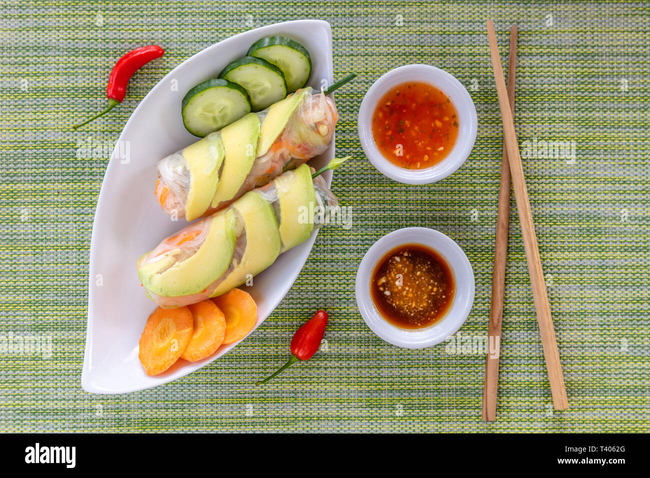 Vietnamese vegetarian spring rolls served with sauces. Wooden ...
