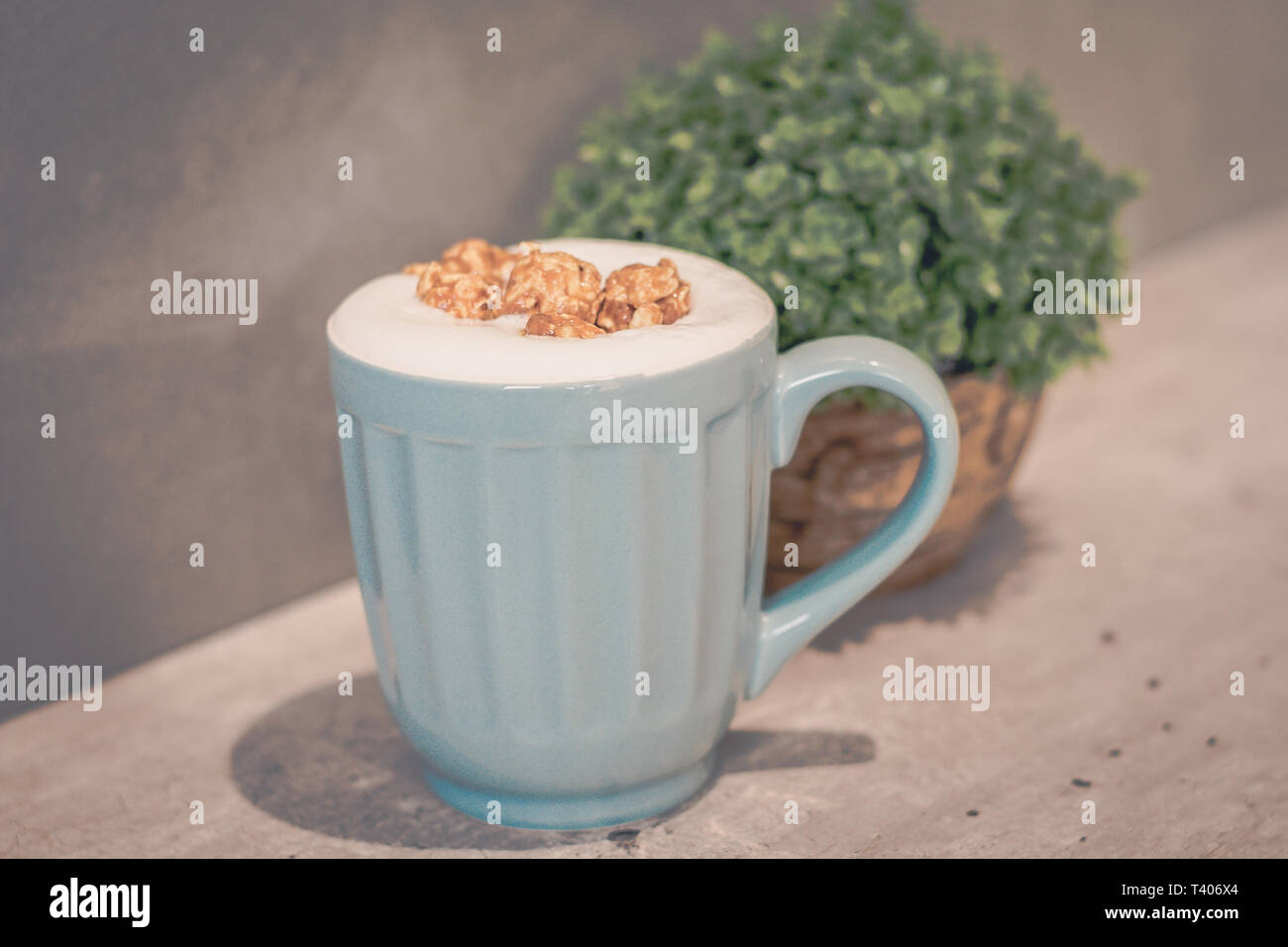 Caramel Popcorn Latte (no caffeine) in light blue mug and potted plant ...