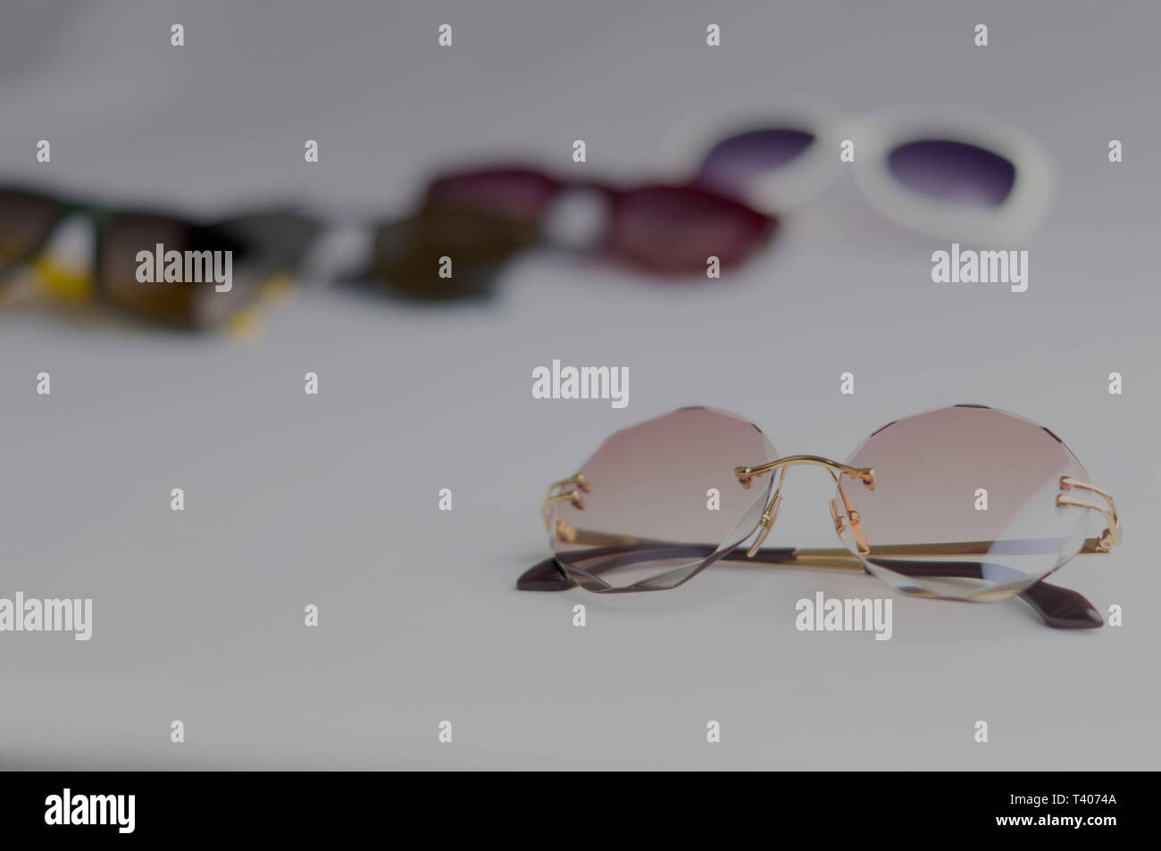 five different color sunglasses and modern Stock Photo - Alamy