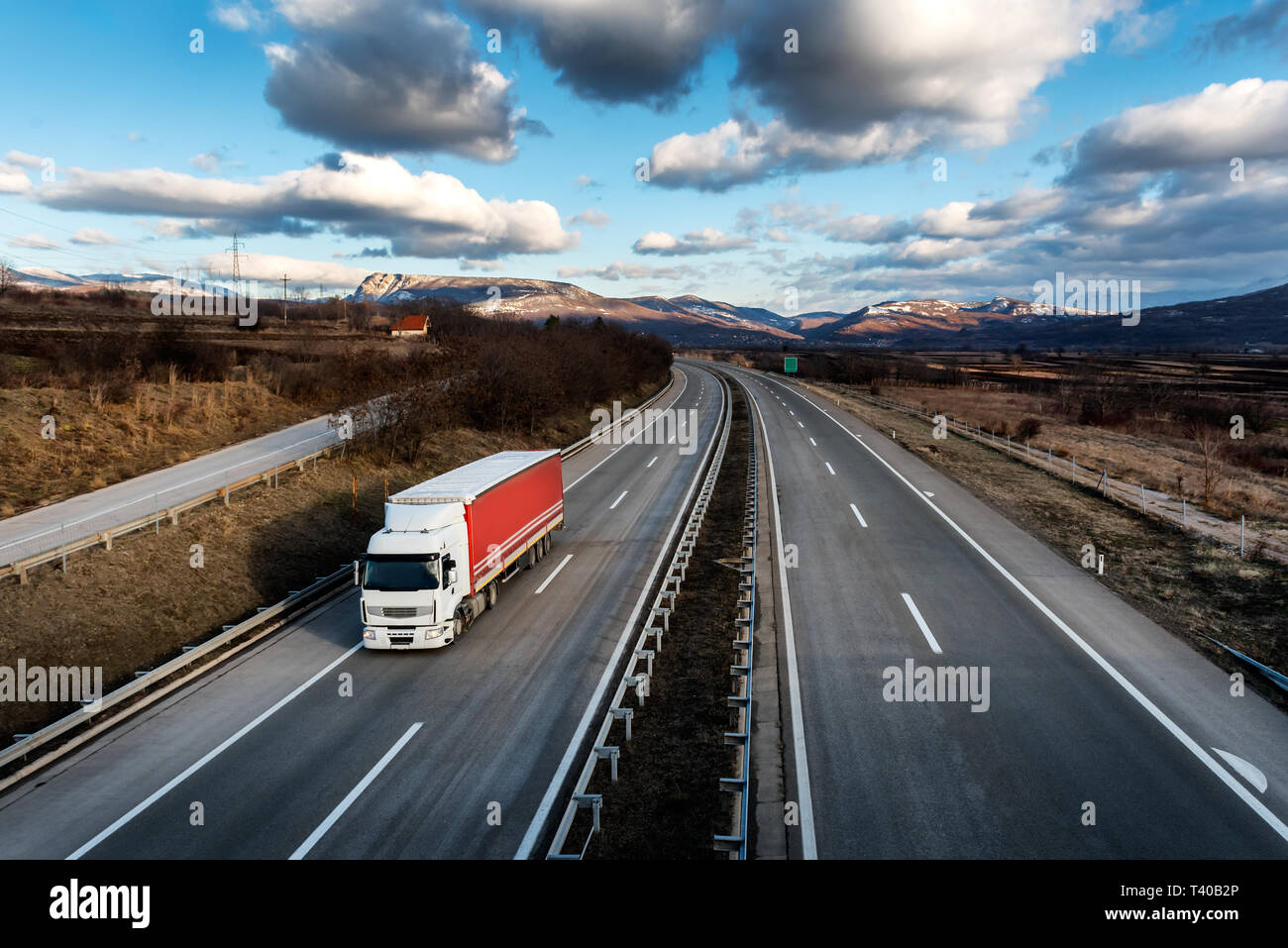 Single lorry truck on country highway under a beautiful sky Stock Photo ...