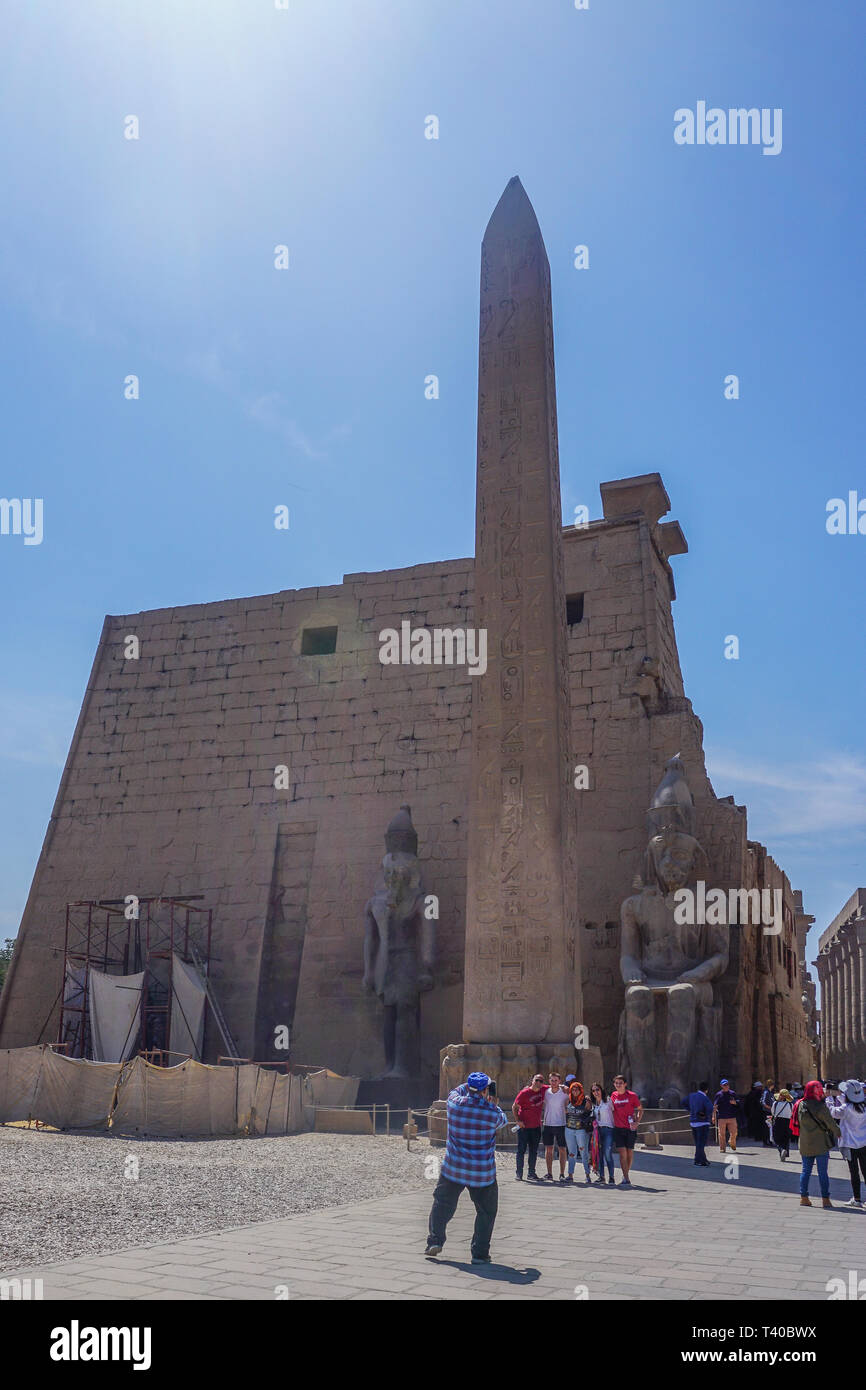 Luxor, Egypt: Groups of tourists at the entrance to the first pylon of ...