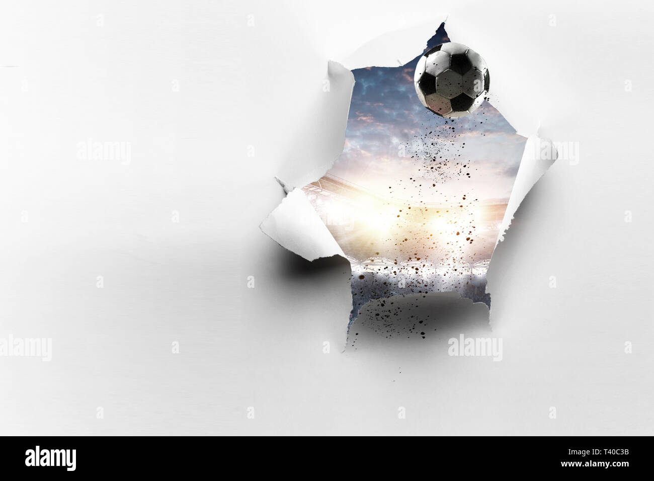 Paper torn hole effect with flying ball Stock Photo - Alamy