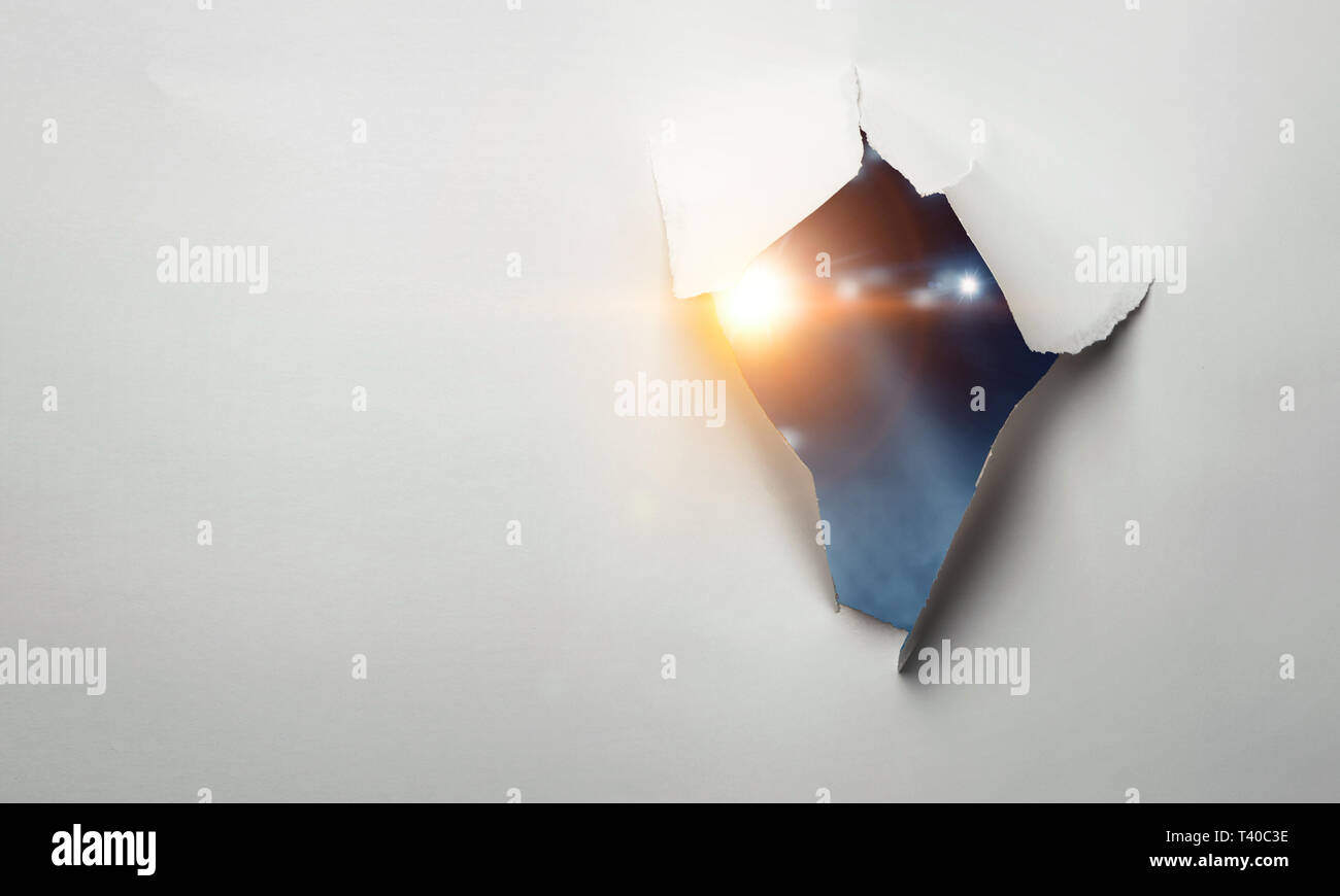Paper torn hole effect with stadium view Stock Photo - Alamy