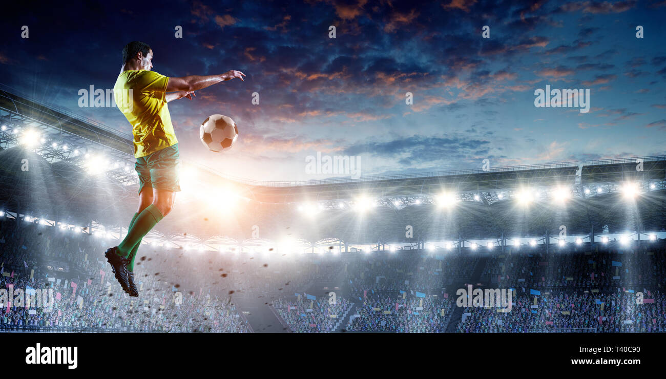 Soccer player on stadium in action. Mixed media Stock Photo - Alamy