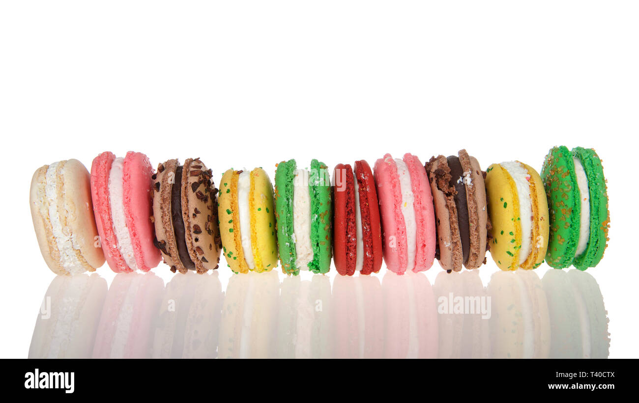 Row of macaron cookies laying sideways side by side multiple colors and ...