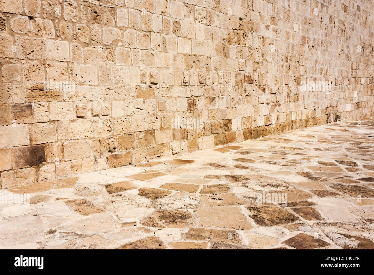 Old, brown, sandy, wall of a stone house in the open air. Seamless ...