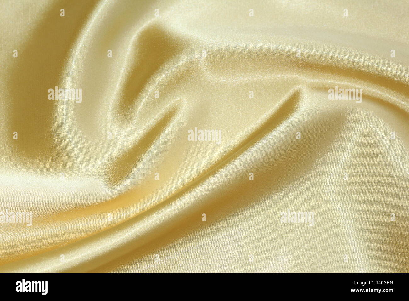 The texture of the yellow material. Bright yellow silk. Golden ...