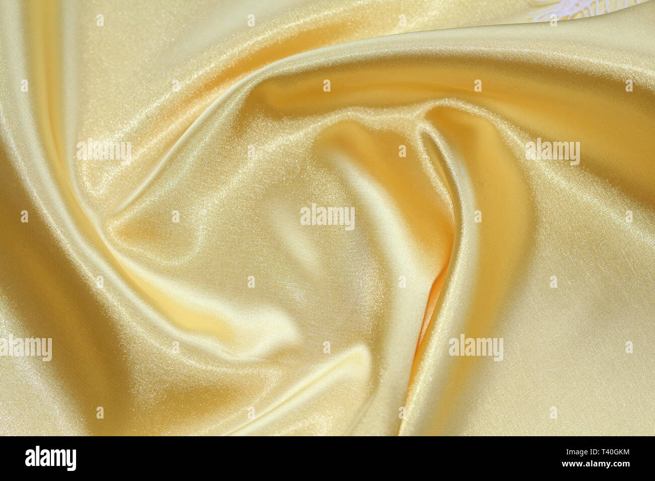 The texture of the yellow material. Bright yellow silk. Golden ...