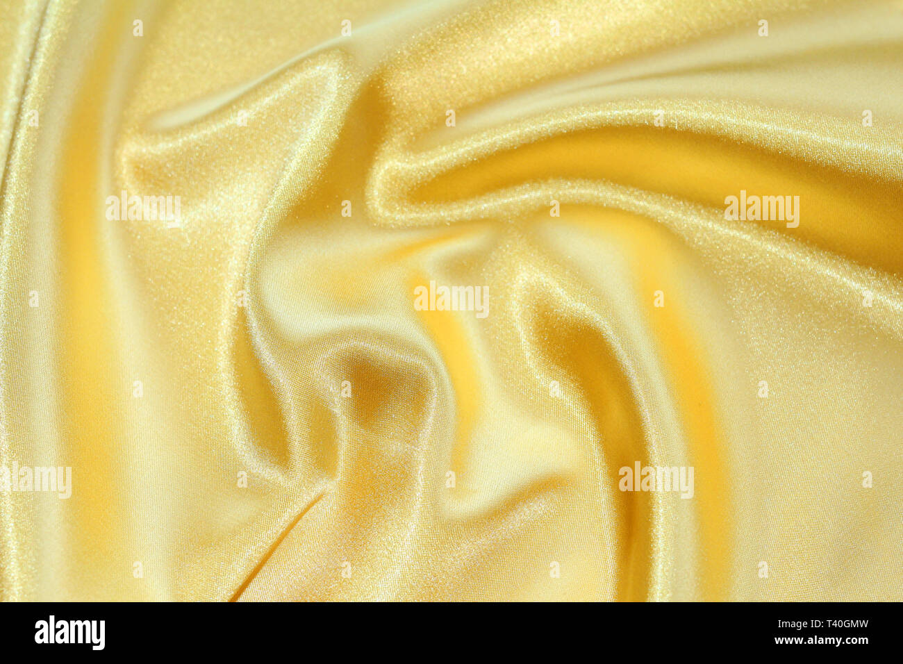 The texture of the yellow material. Bright yellow silk. Golden ...
