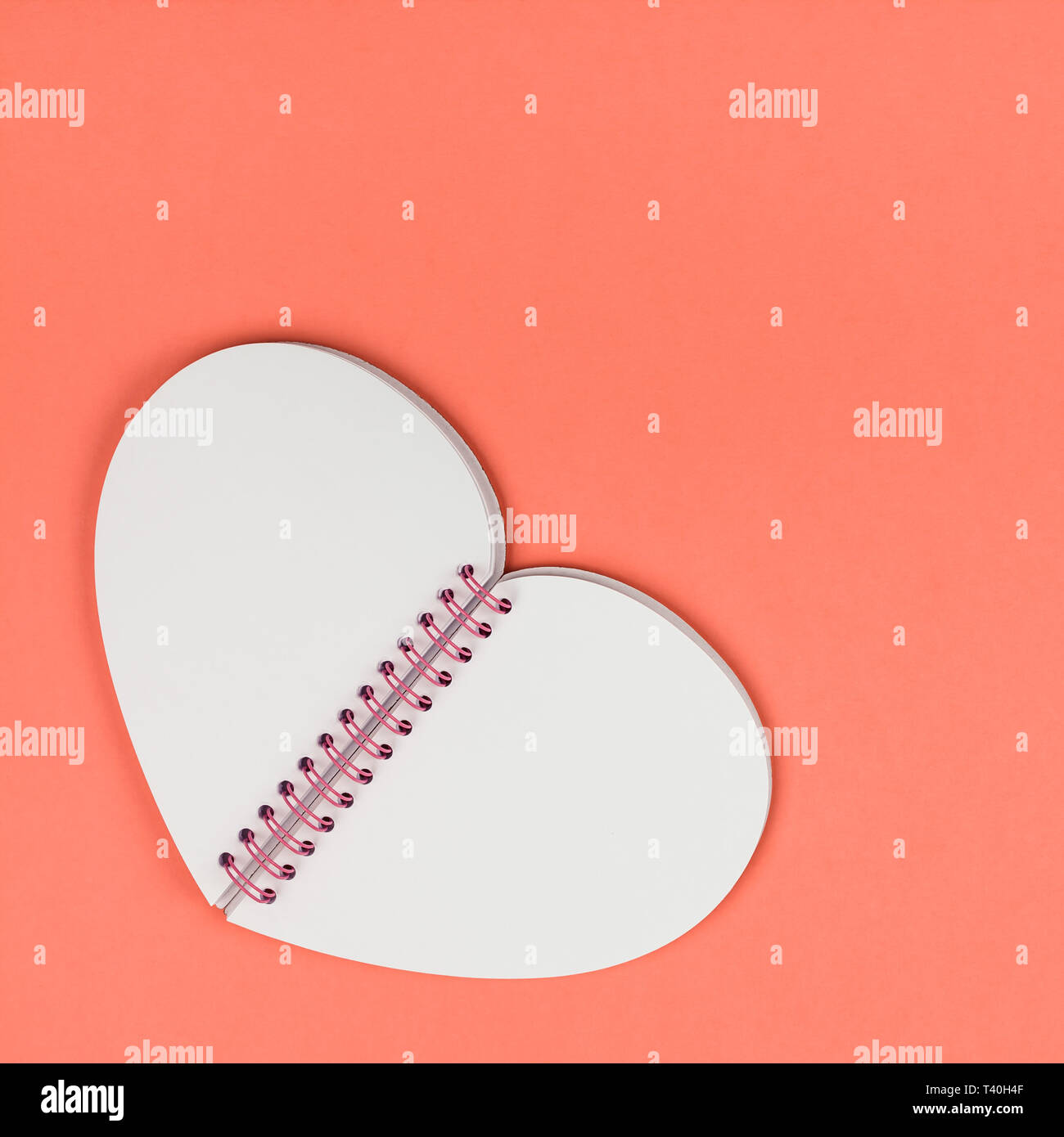 Creative top view flat lay of heart shaped notepad with blank pages as ...